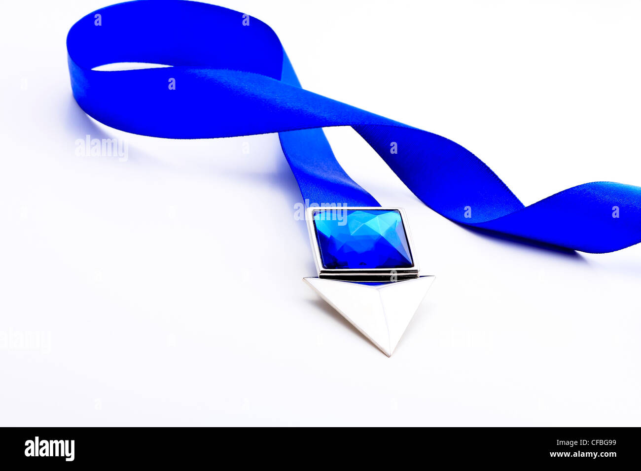 triangle silver pin with blue stone and blue ribbon Stock Photo - Alamy