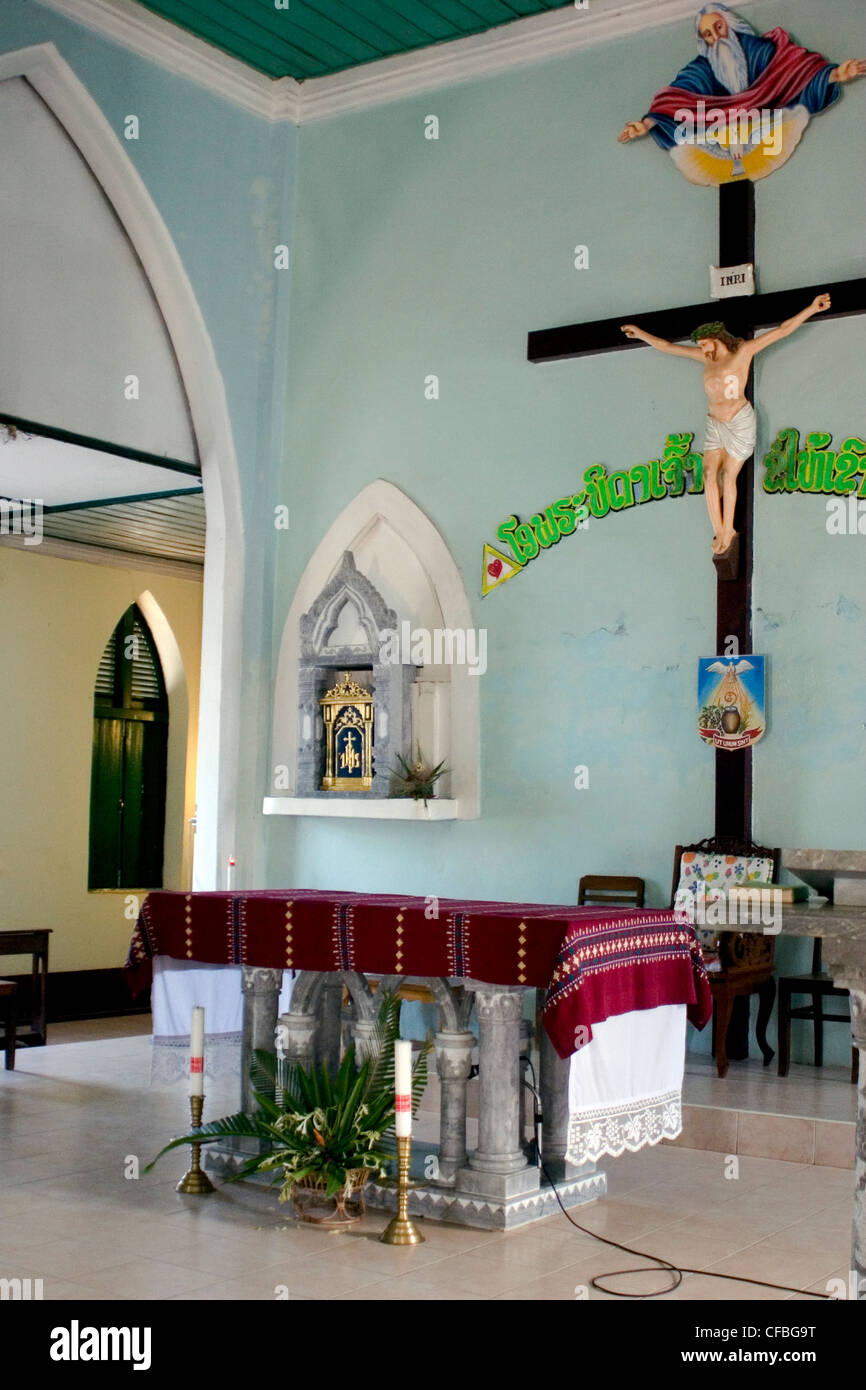 Jesus Christ is displayed on a cross inside a Christian church in Pakse ...