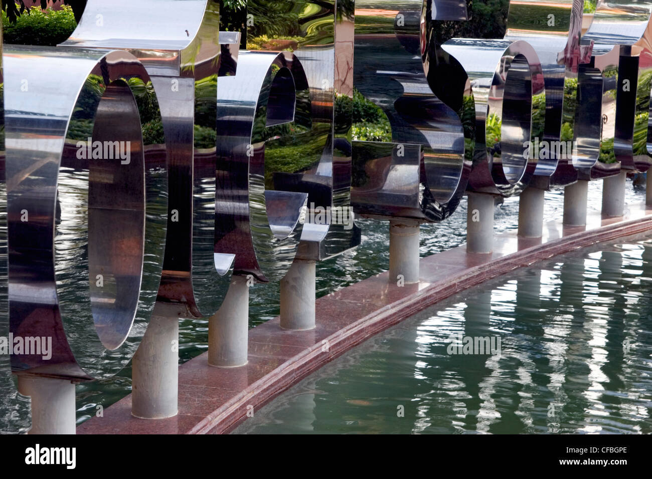 A modern chrome sign marks the location of the Sofitel Hotel in urban ...