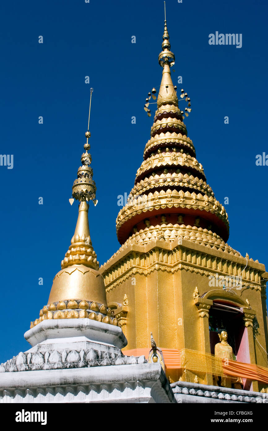 Gold stupas with Buddha statues are on display at a Buddhist temple in ...