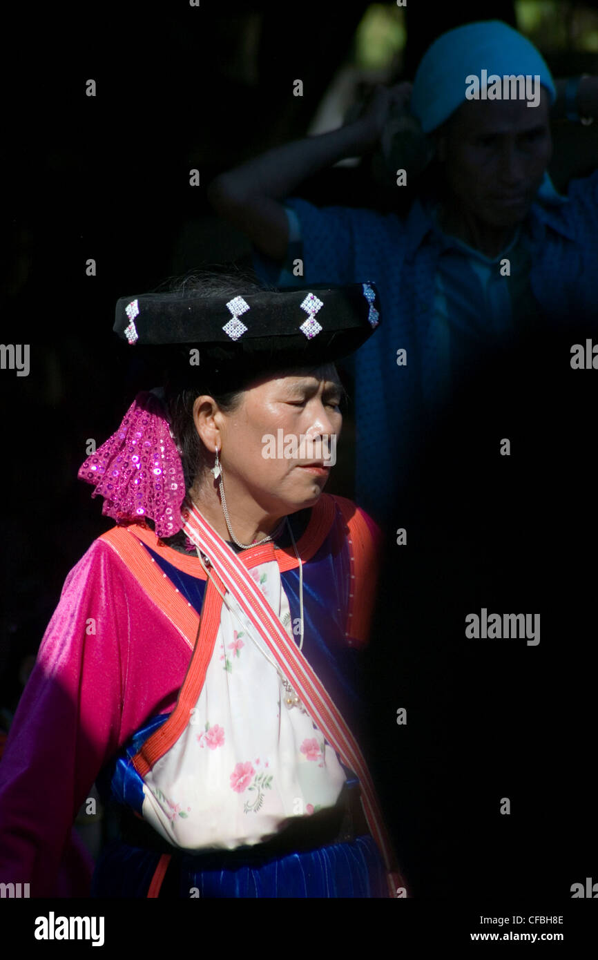 An ethnic Lisu women is attending a traditional dance ceremony in Pai ...