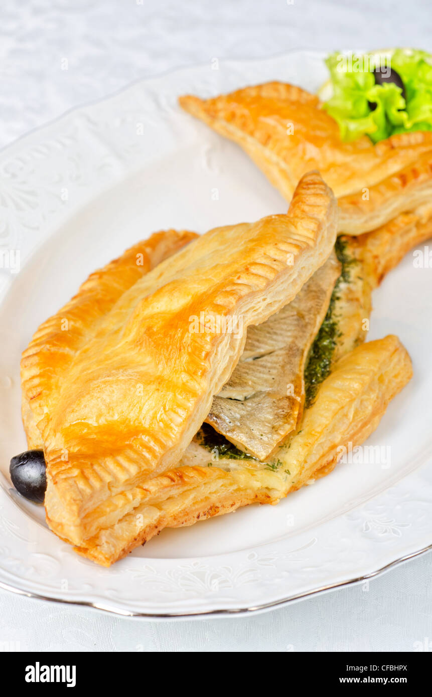 tasty dish of trout fish baked with greens at dough Stock Photo - Alamy
