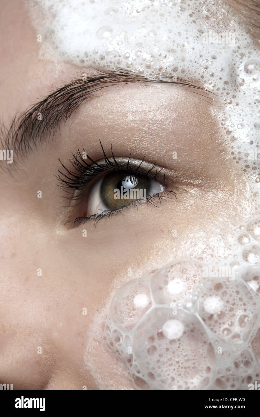 Cropped Female face with brown eyes with face wash on her cheek Stock ...