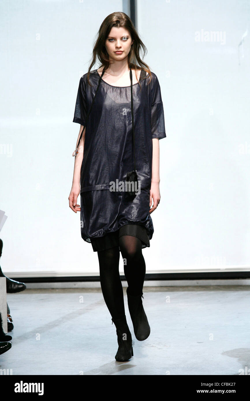 Model Bettina wearing black loose smock dress in shimmery fabric, scoop ...