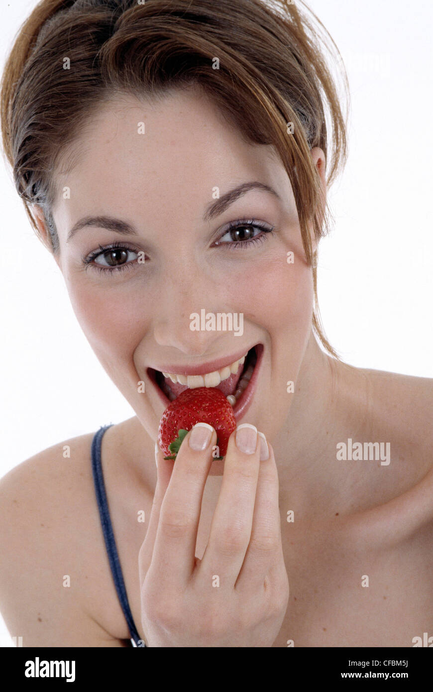 Female eating strawberry Stock Photo - Alamy