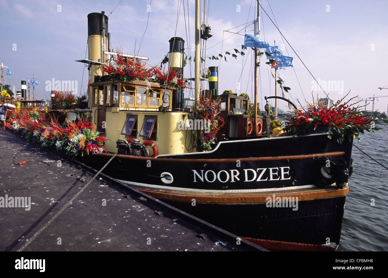 Dutch tugboat decorated with flowers, SAIL 2005. Amsterdam, The ...
