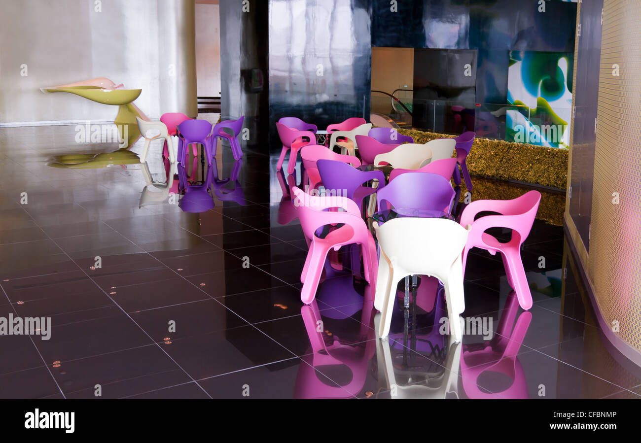 plastic chairs in the interior of a tall building Stock Photo - Alamy