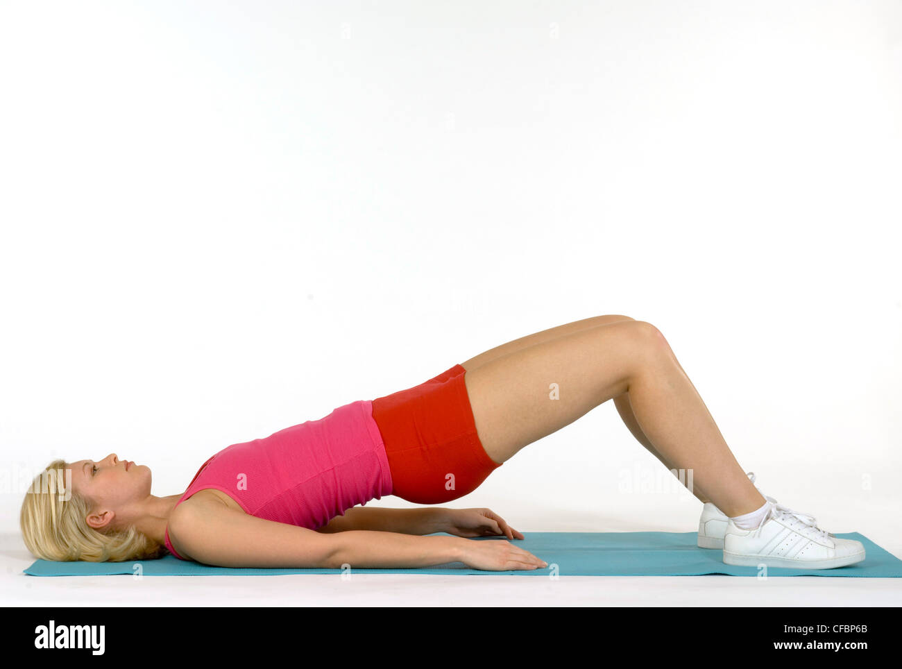 Female doing stomach toning exercise Stock Photo - Alamy