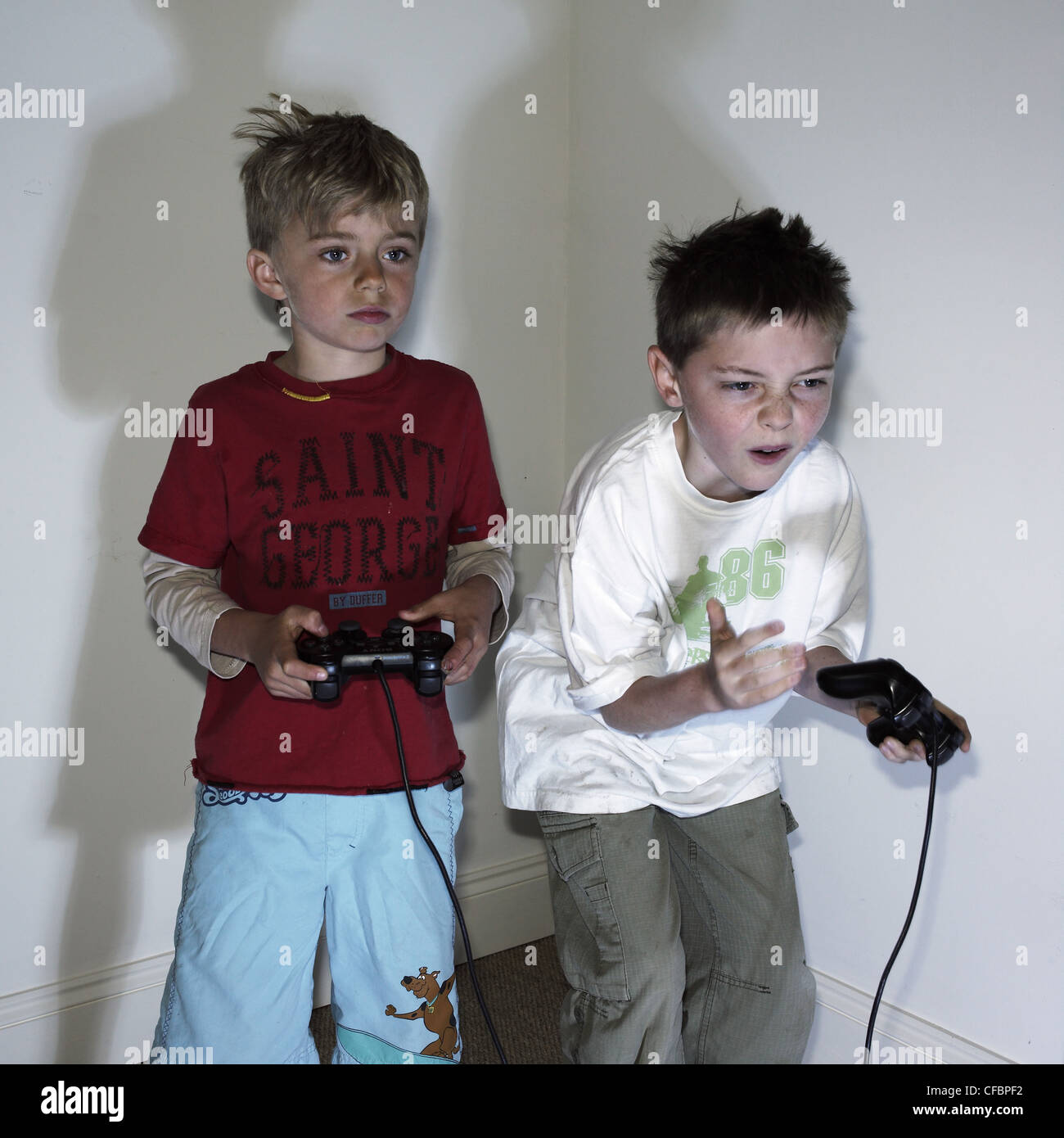 Two male children playing computer games Stock Photo - Alamy