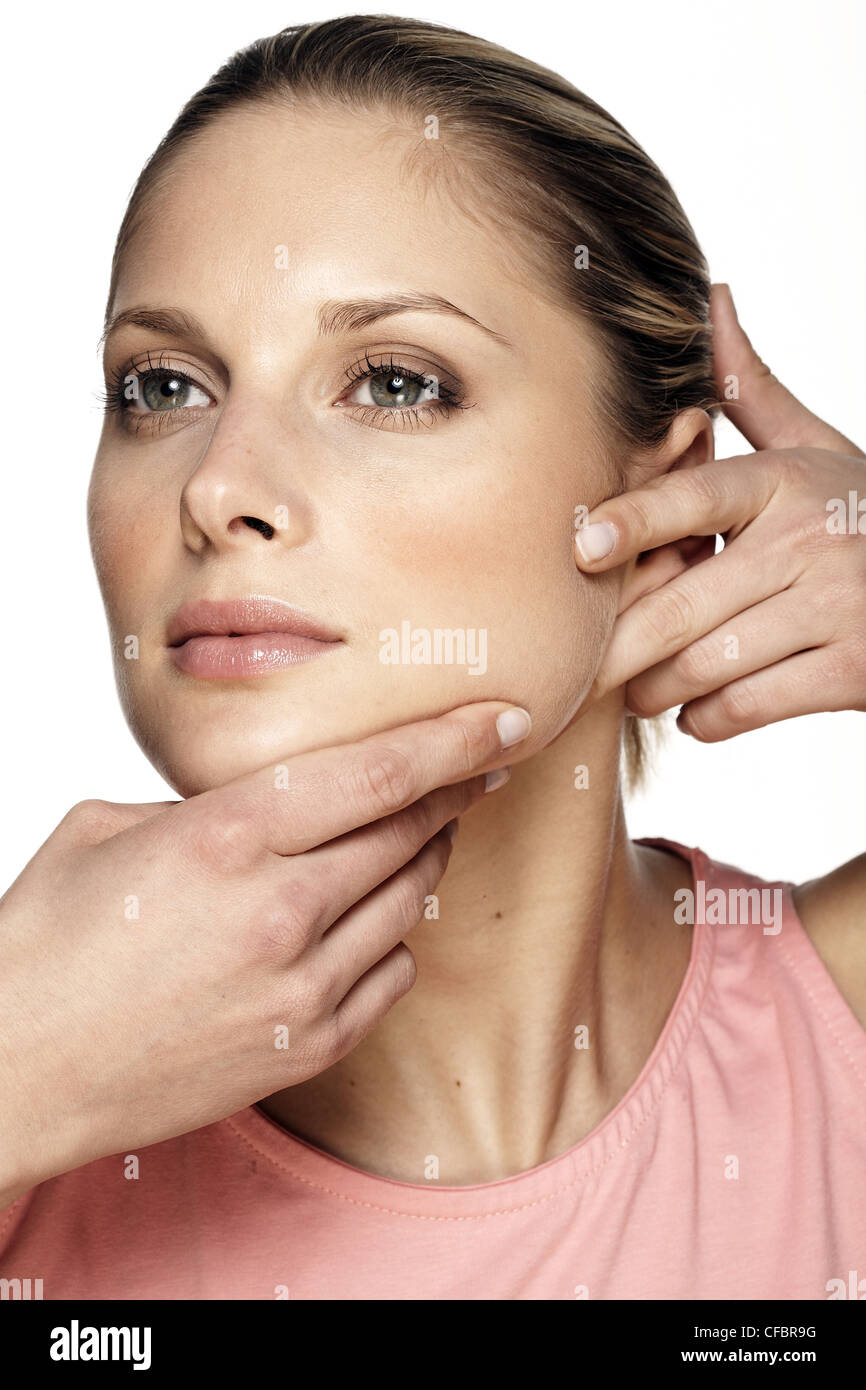 Female touching face and neck with hands Stock Photo - Alamy