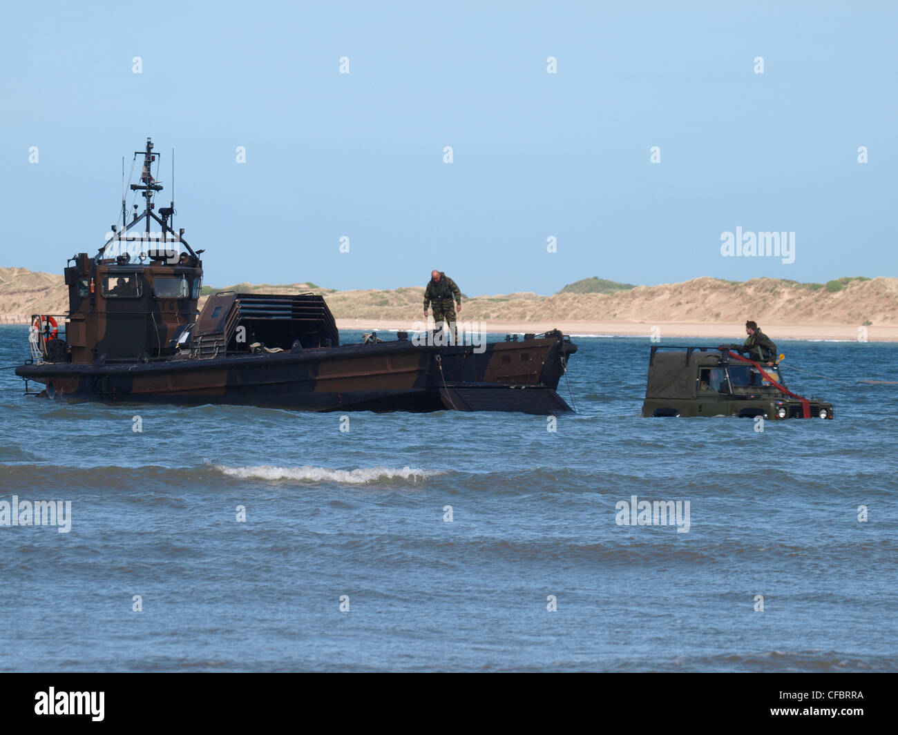 Royal Marines land rover driving off a landing craft, Devon, UK Stock ...