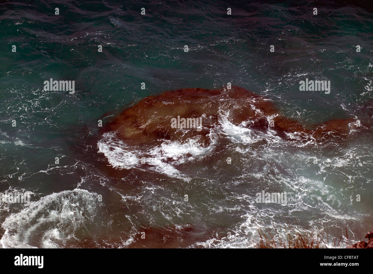 Submerged rocks pouinded by the sea on the south shore section of ...