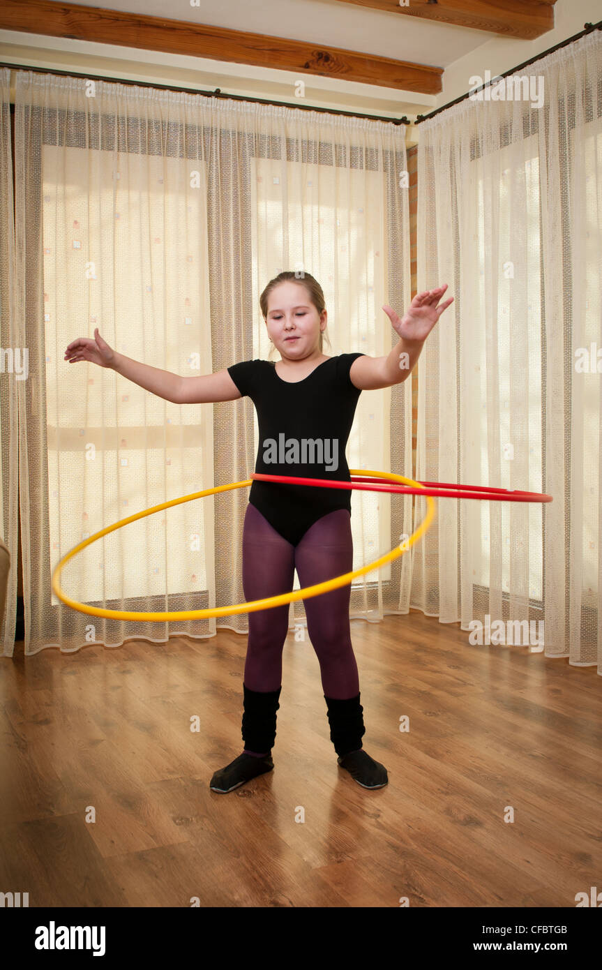 Young girl show gymnastics dance with hoop at home Stock Photo - Alamy