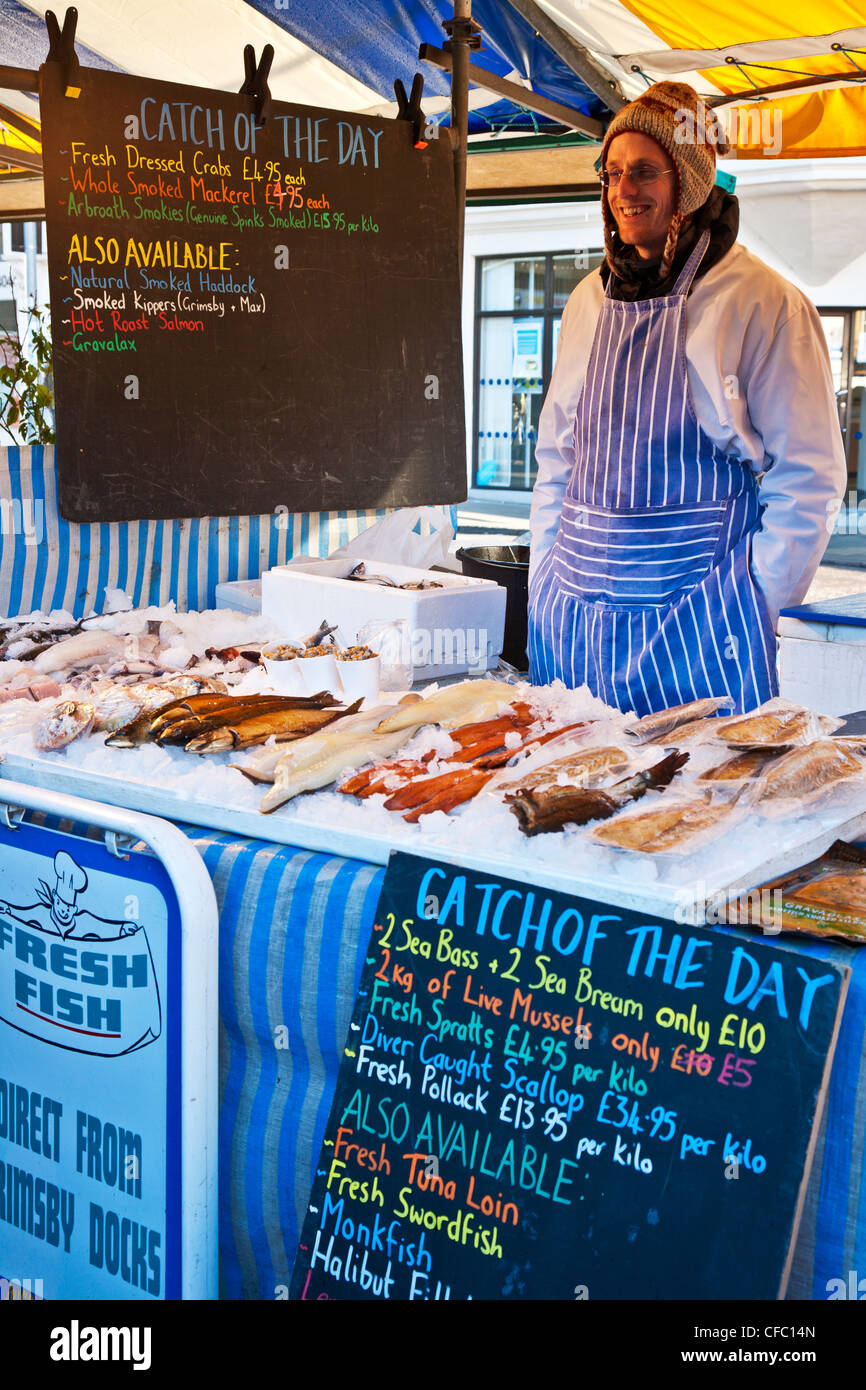 Fishmonger behind a fresh fish stall in the Market Square, Cambridge ...