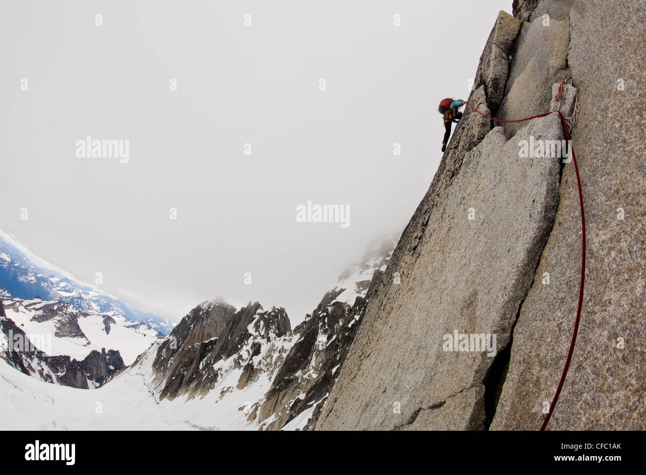 A female climber ascends the Northeast Ridge - North Howser, Bugaboos ...