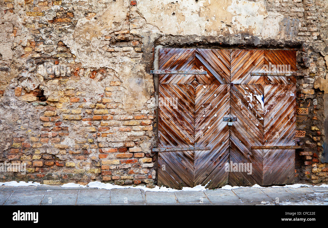 Wooden doors in a crumbling wall in Vilnius, Lithuania Stock Photo - Alamy