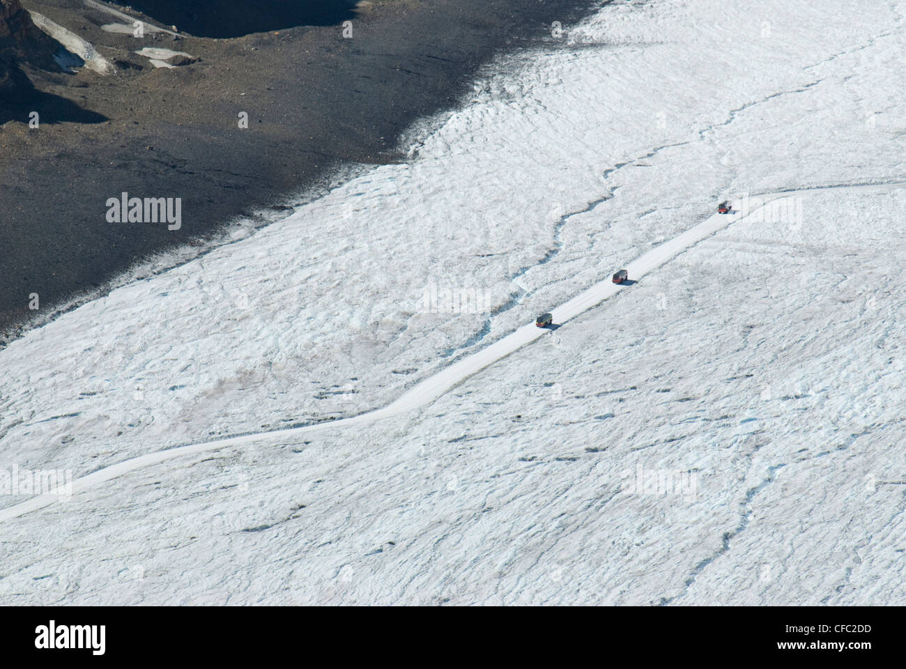 Three buses traverse the ice on the Athabasca Glacier, Icefields ...