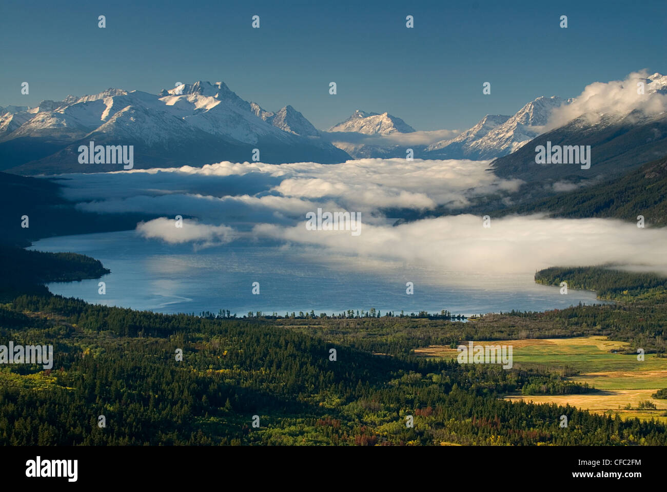 Tatlayoko Lake, showing farm fields, clouds and the Coast Mountains ...