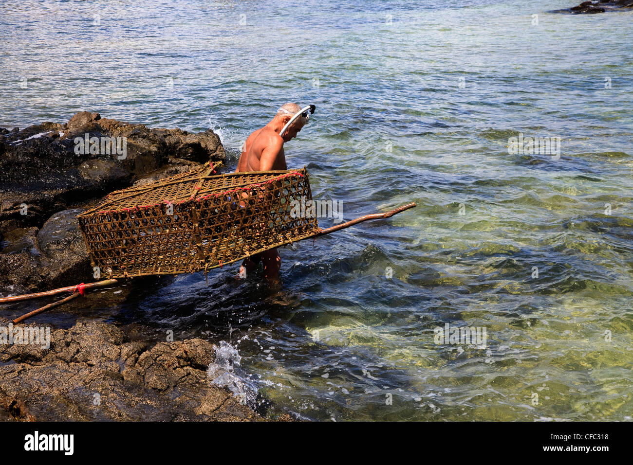 Local fisherman using traditional methods of fishing with a wicker ...