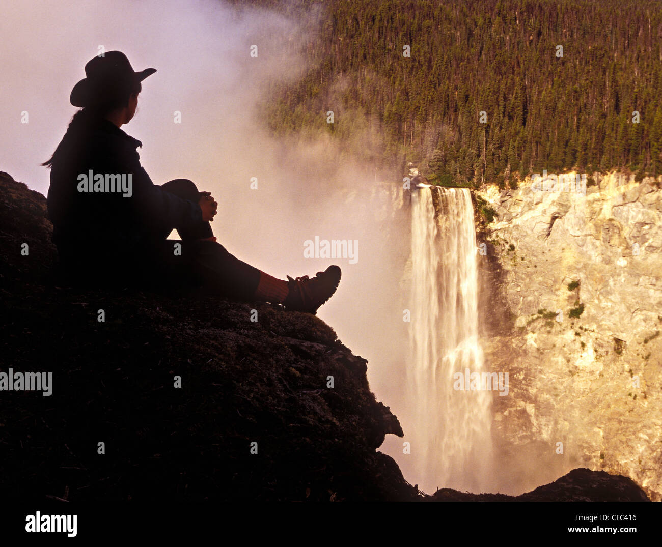 Hiker overlooks Hunlin Falls in Tweedsmuir Park in British Columbia ...
