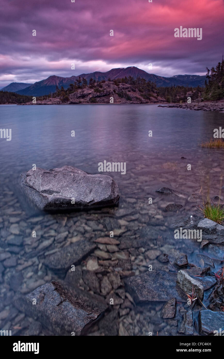 Sunsetlight illuminates some clouds above Atlin Lake in Atlin ...