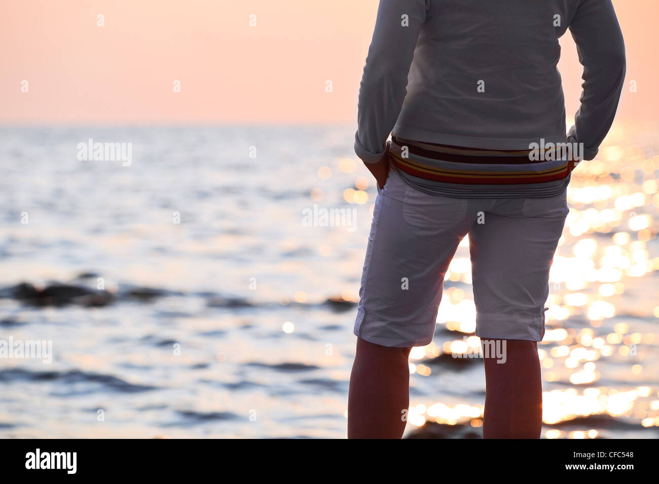 Woman watching sunset over Lake Winnipeg. Victoria Beach, Manitoba ...