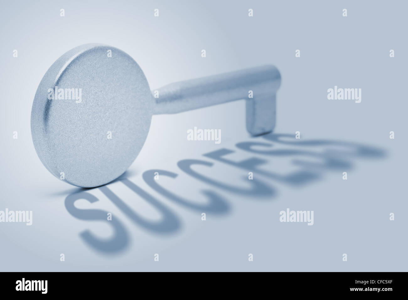 Silver key with shadow that spells success Stock Photo - Alamy