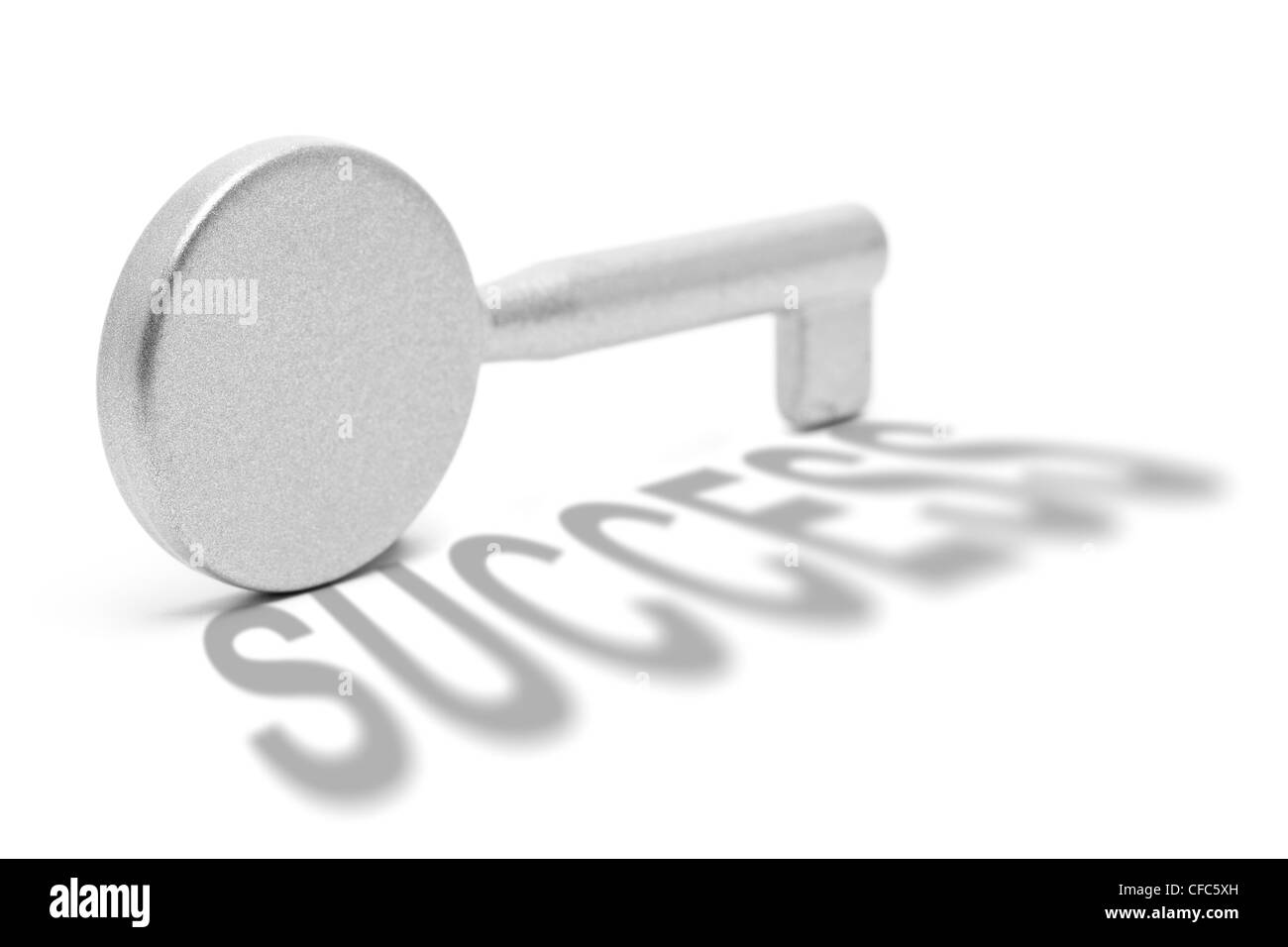 Silver key with shadow that spells success Stock Photo - Alamy
