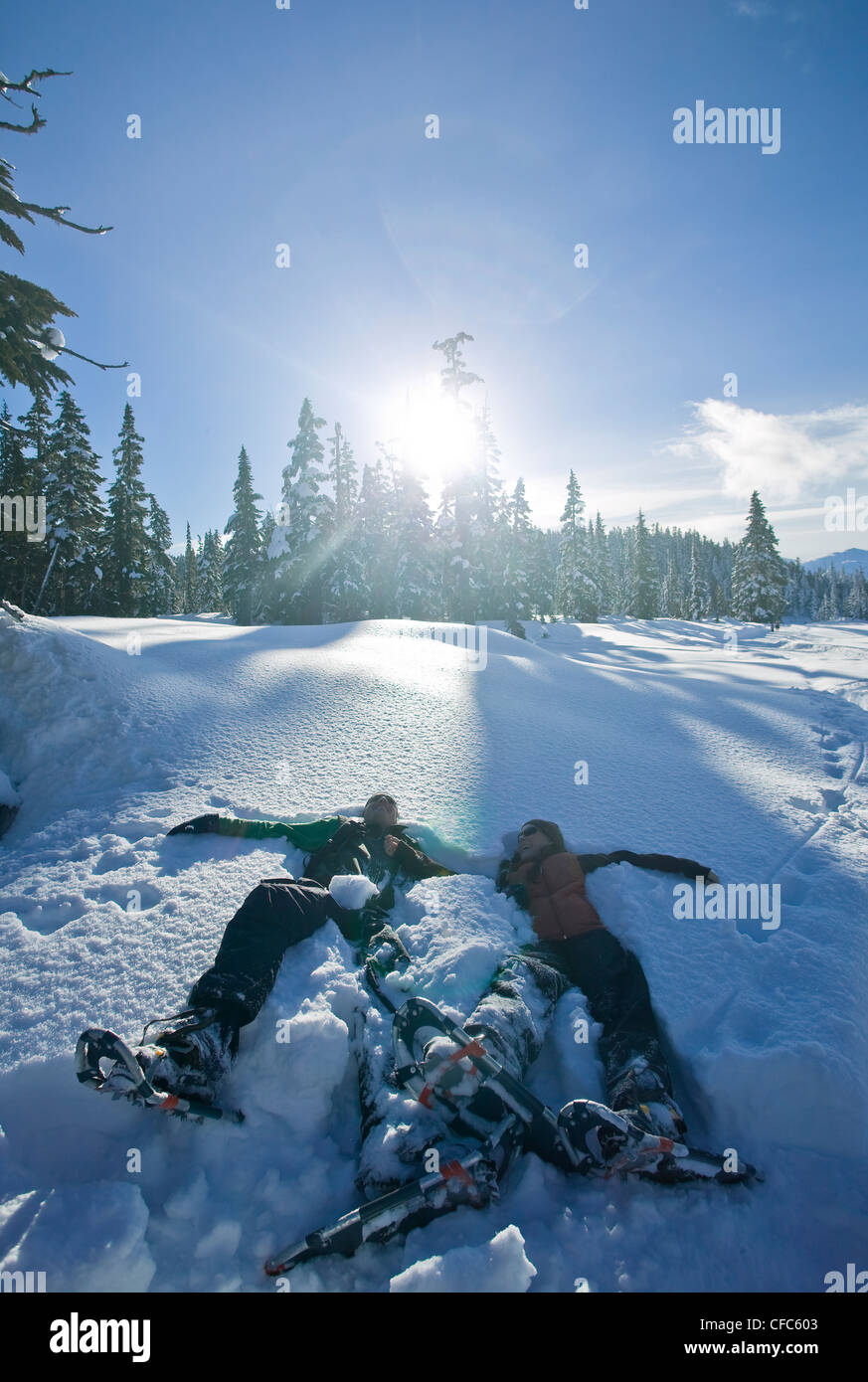 Two Snowshoer's lying down snow Paradise Meadows Stock Photo - Alamy