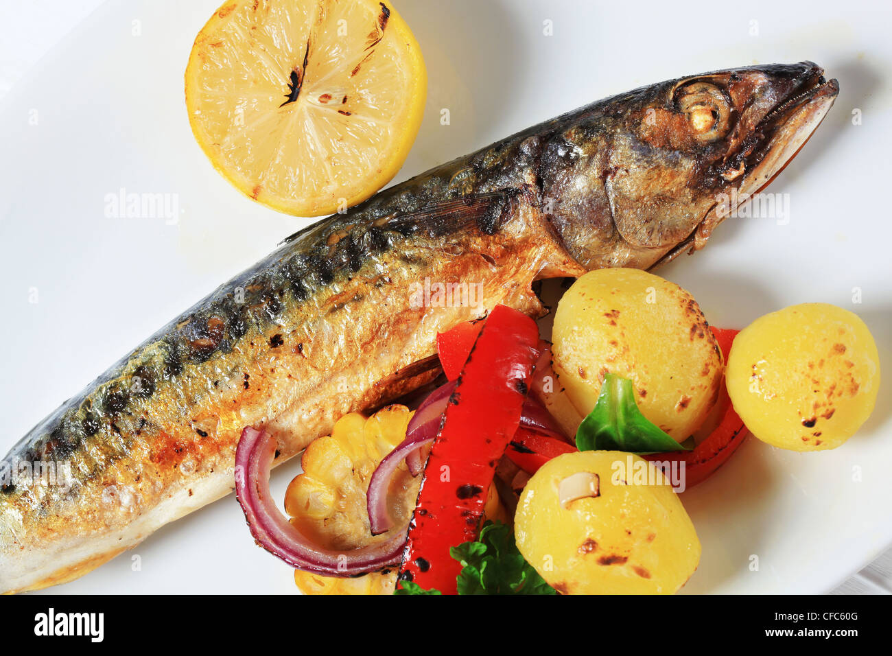 Dish of grilled mackerel and potatoes Stock Photo - Alamy