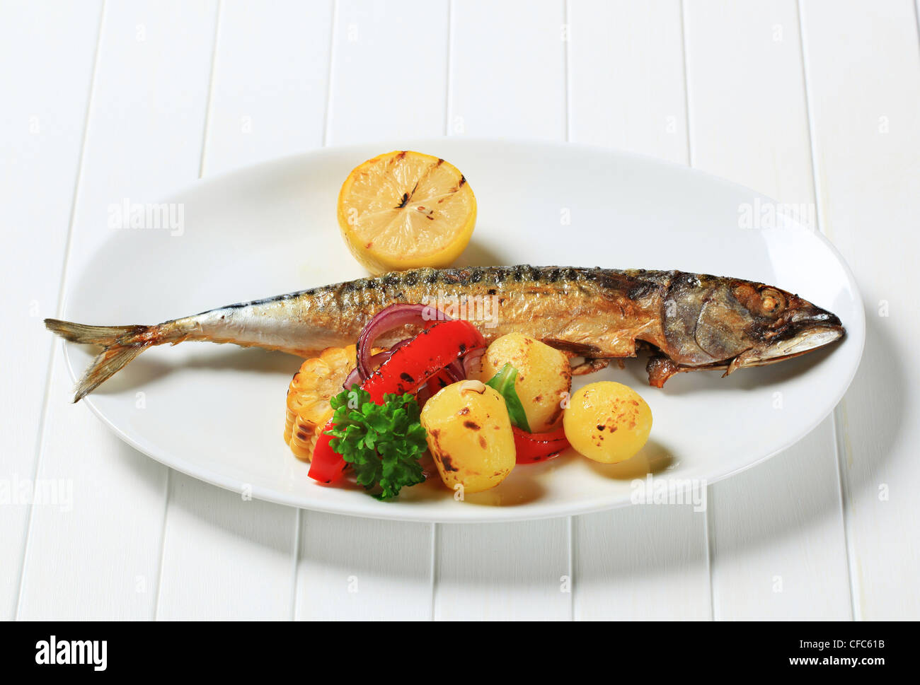 Dish of grilled mackerel and potatoes Stock Photo - Alamy