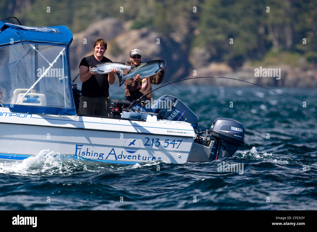 Two fishermen display catch fishing along shores Stock Photo - Alamy