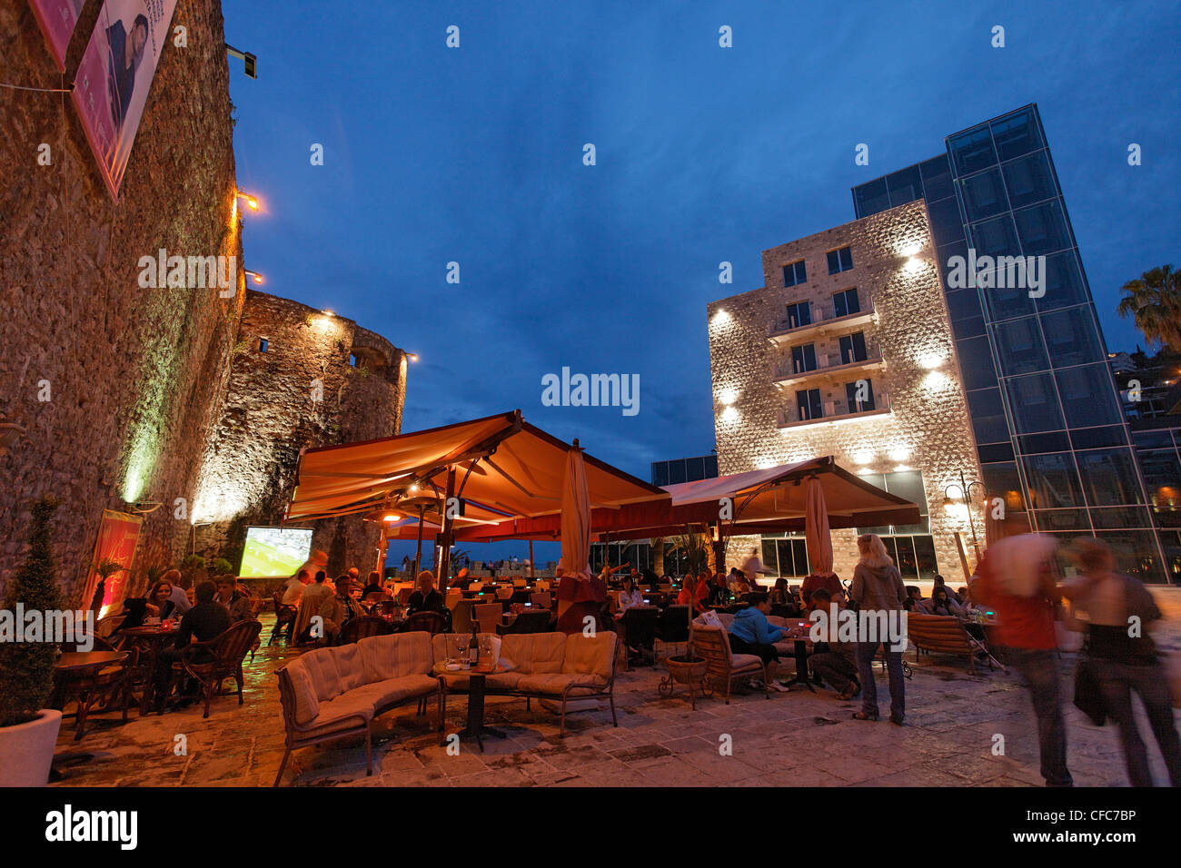 Restaurants at the city wall in the evening, Budva, Montenegro, Europe ...