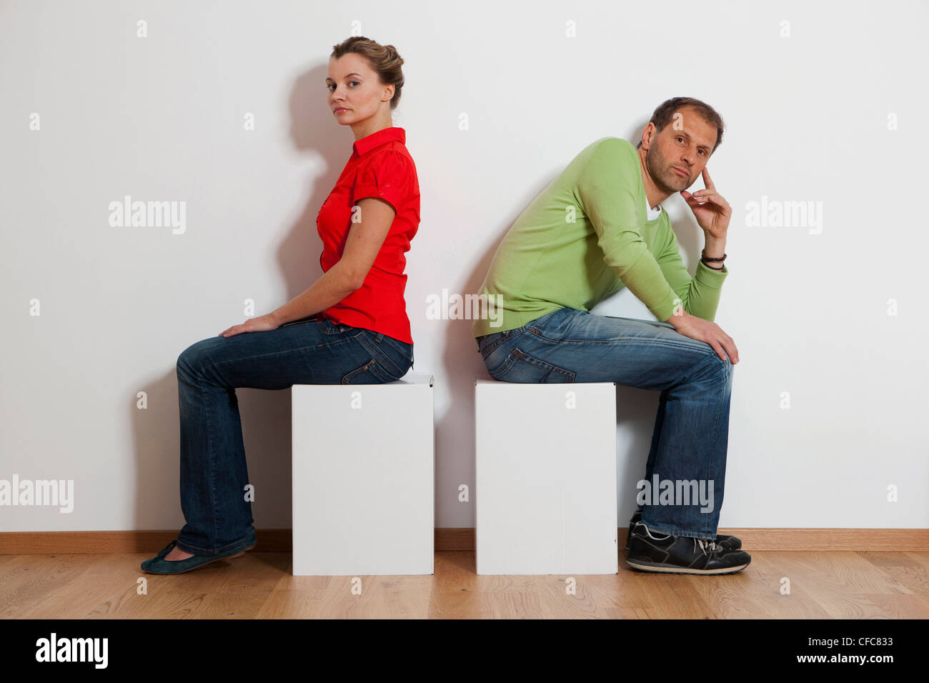 Angry couple sitting back to back, Vienna, Austria Stock Photo - Alamy