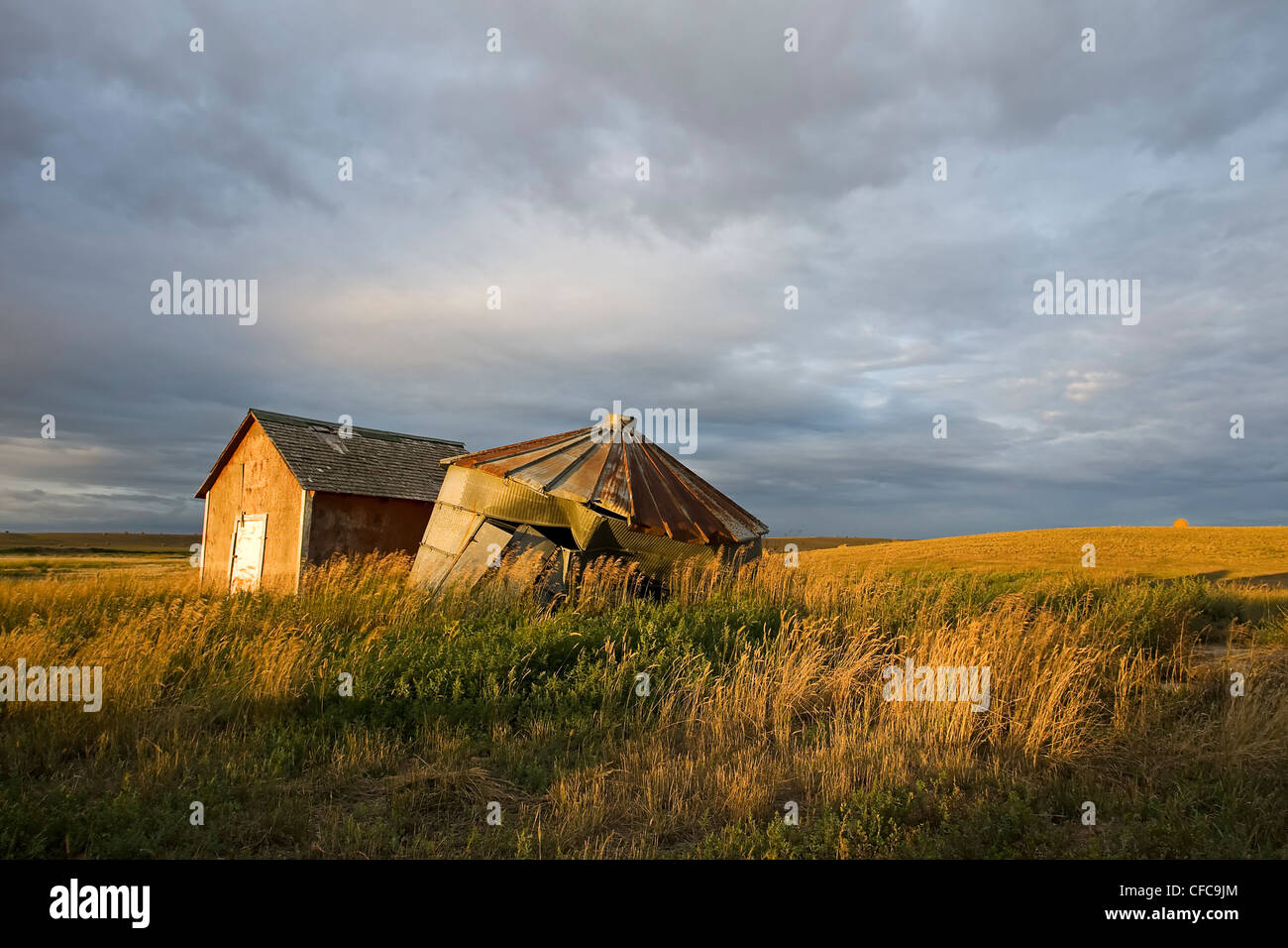 Southern Saskatchewan grain field with old builings. Prairie farmland ...