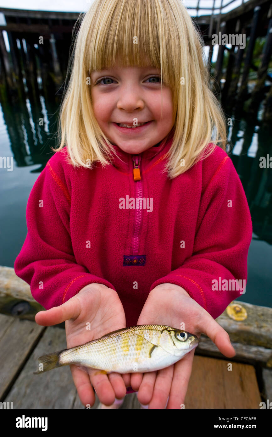 Girl with small fish. M.R Stock Photo - Alamy