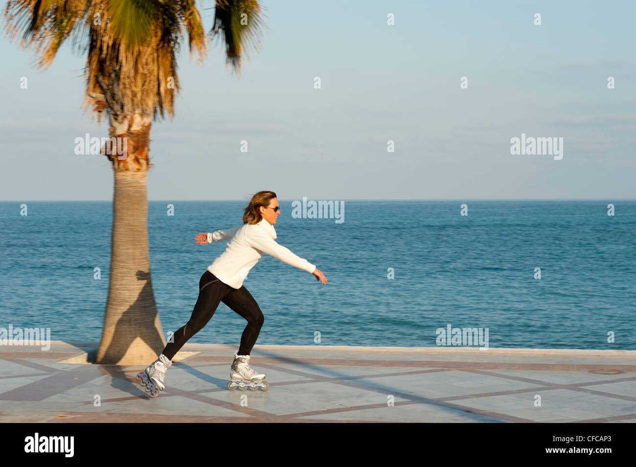 Skating along a beach promenade, shot by camera panning Stock Photo - Alamy