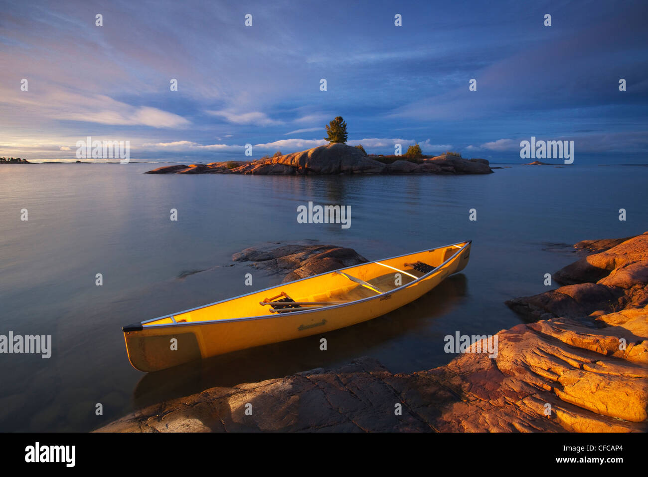 Canoe by granite islands of Georgian Bay, Killarney Provincial Park ...