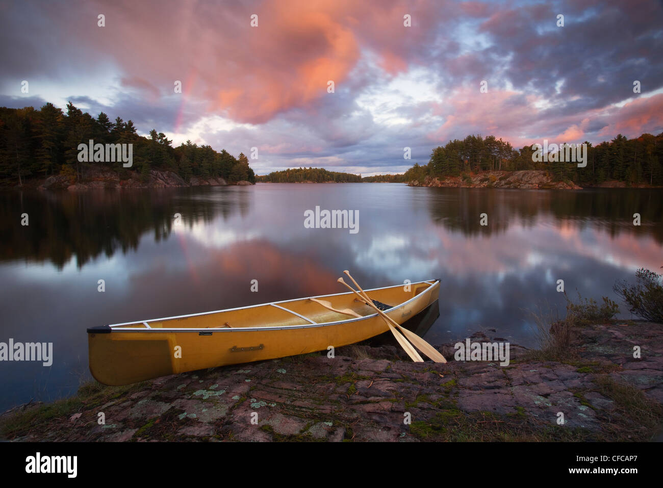 Canoe by granite islands of Georgian Bay, Killarney Provincial Park ...