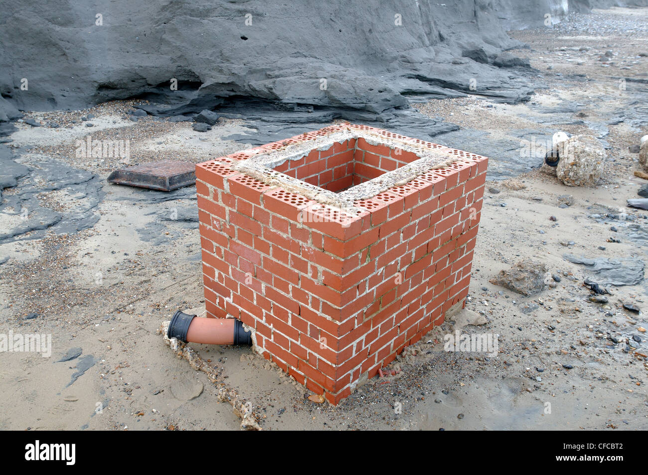 A Manhole with it`s cover lay on the beach after falling from the ...