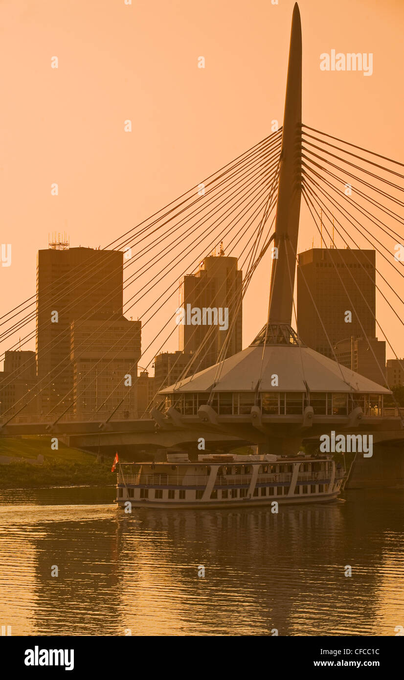 Winnipeg skyline from St. Boniface with river cruise boat going under ...