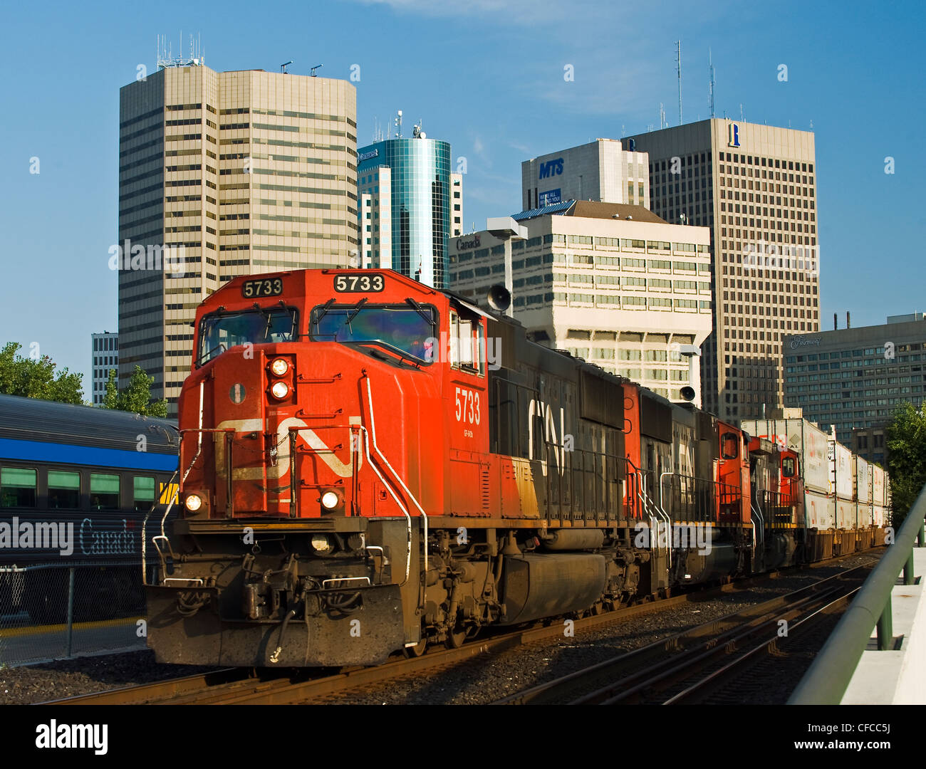 a train carrying shipping containers passes through downtown Winnipeg ...