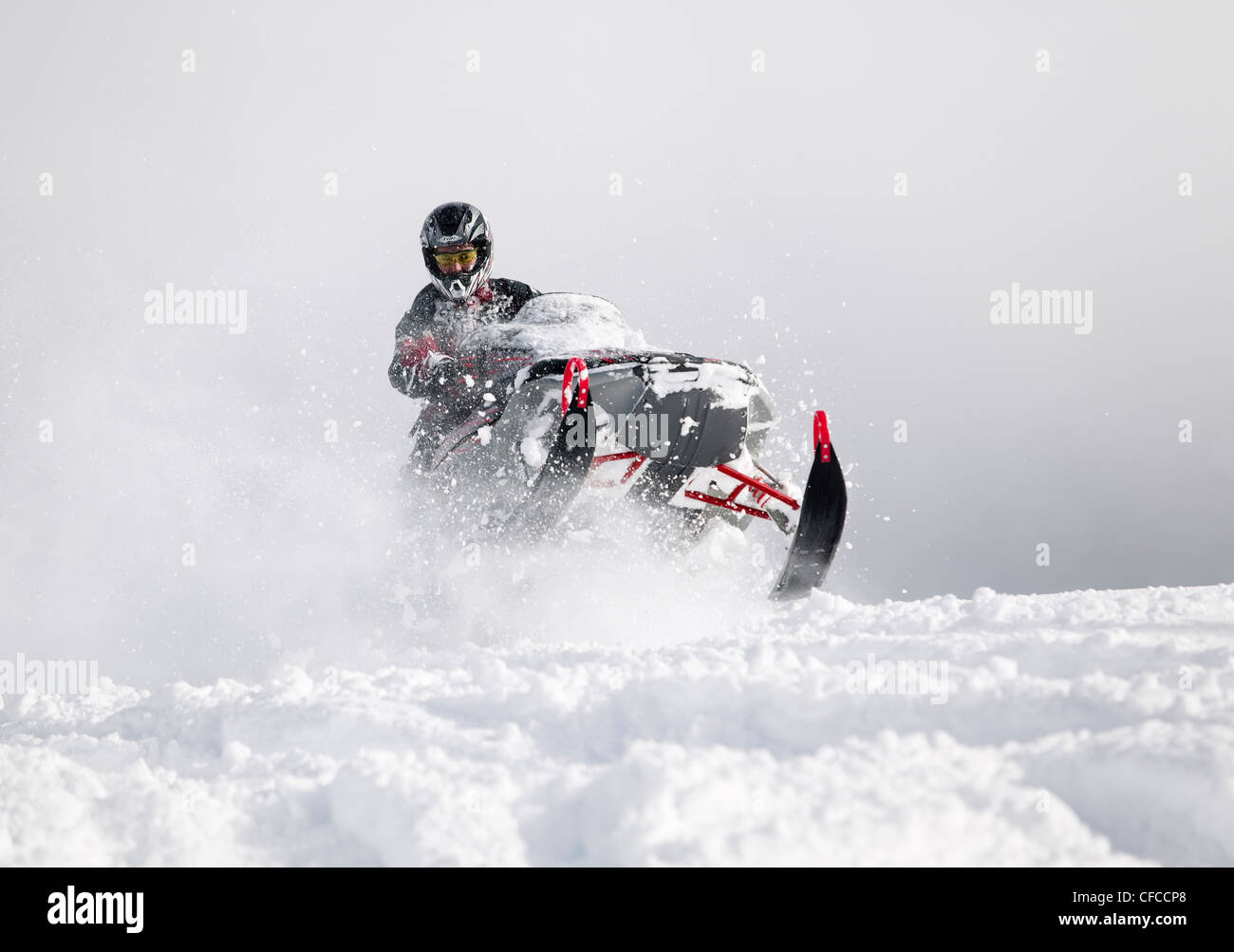 Fresh deep powder greets this snowmobiler Stock Photo - Alamy