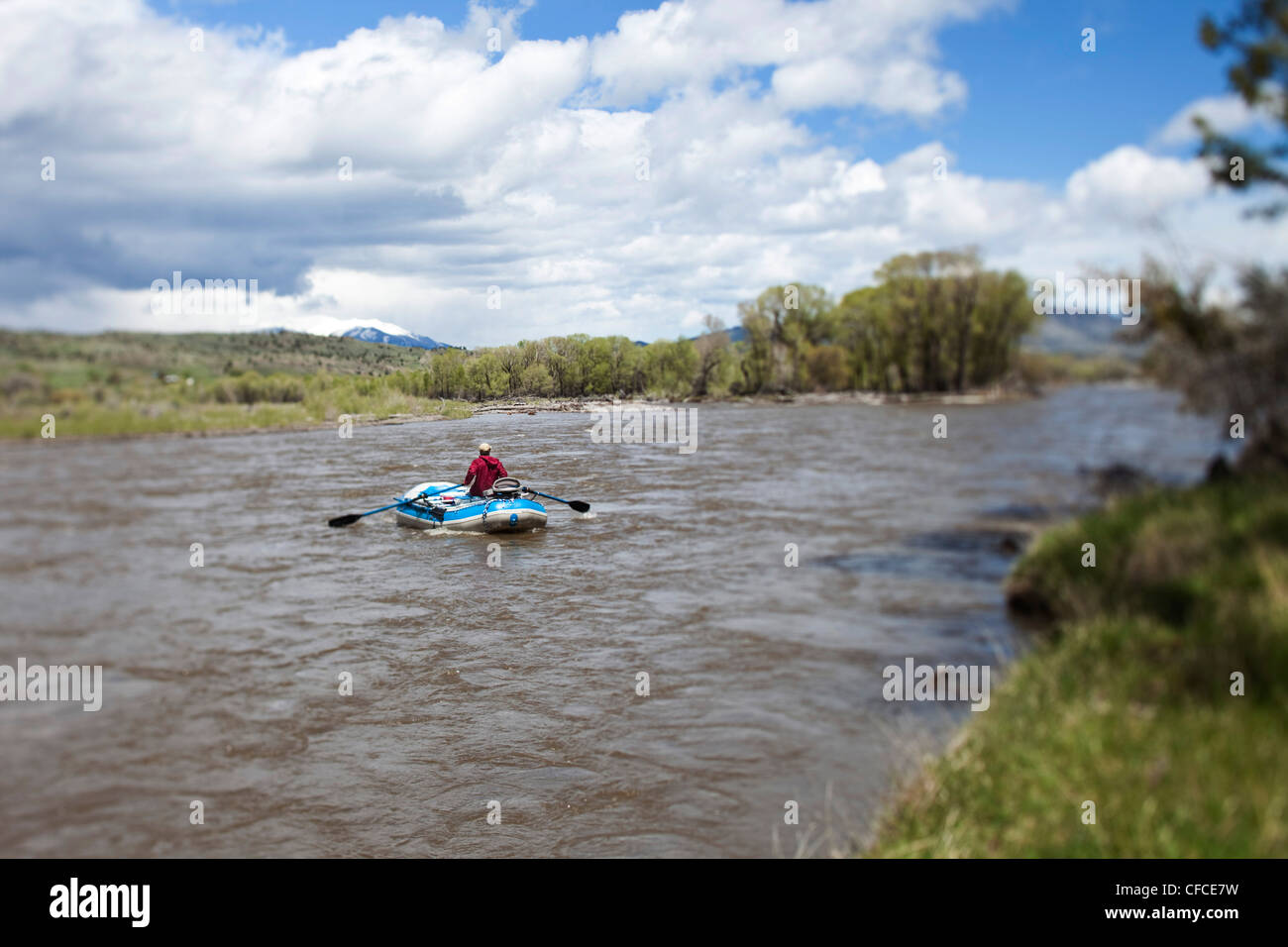 A man rafts down a river on a beautiful day in Montana Stock Photo - Alamy