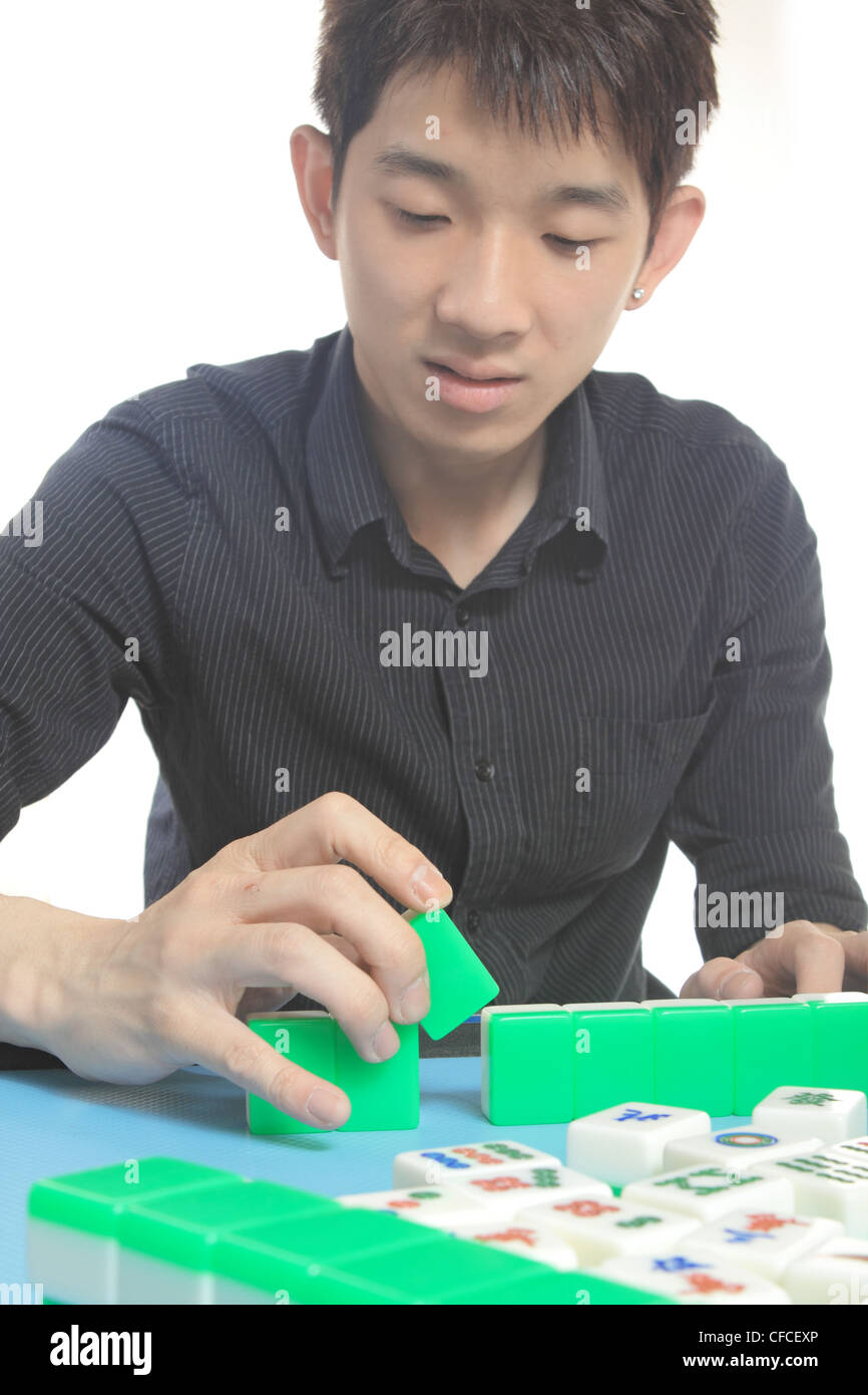 Chinese man play Mahjong, traditional China gamble Stock Photo - Alamy