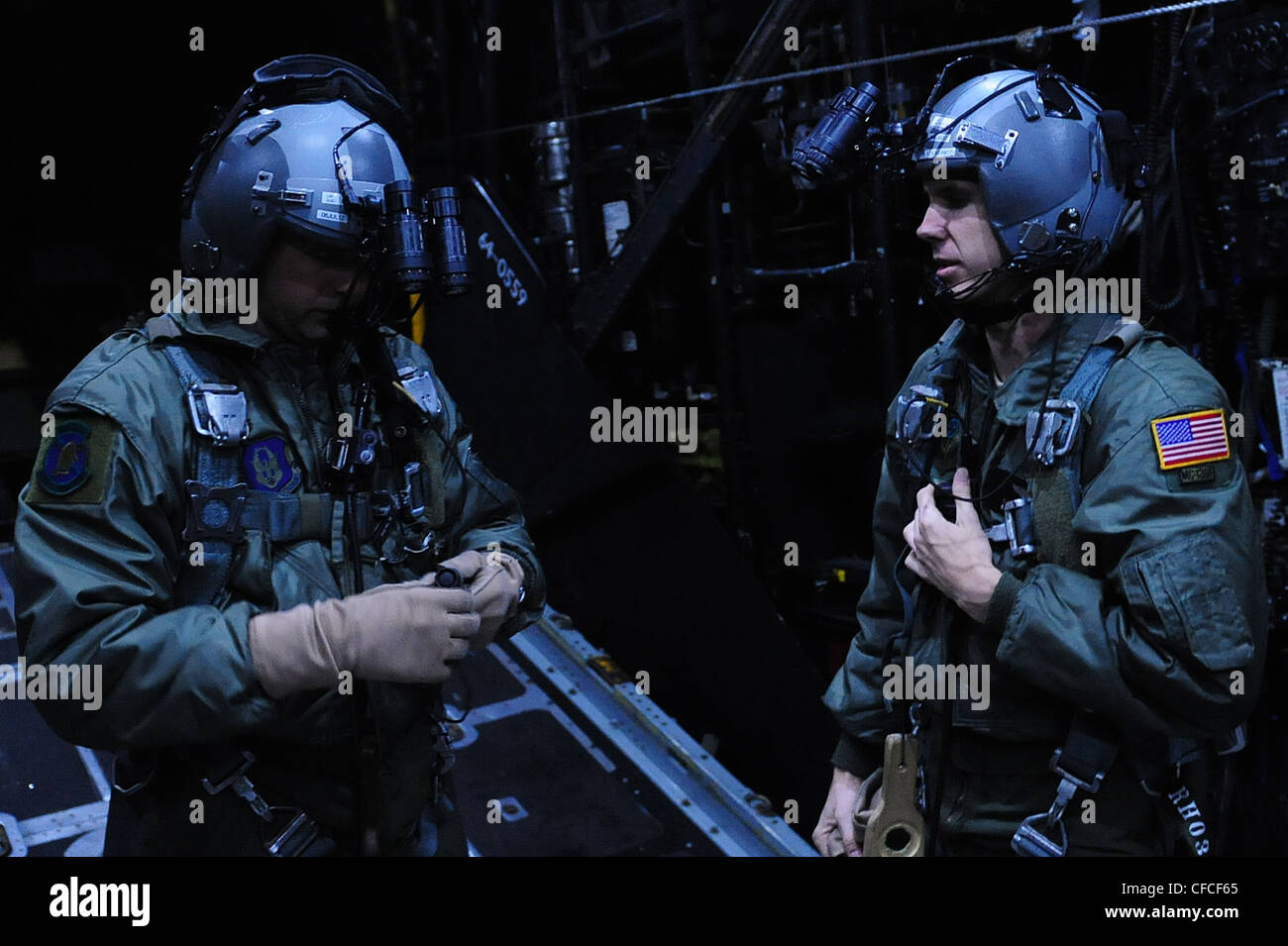 U.S. Air Force load masters work aboard a MC-130E aircraft during ...