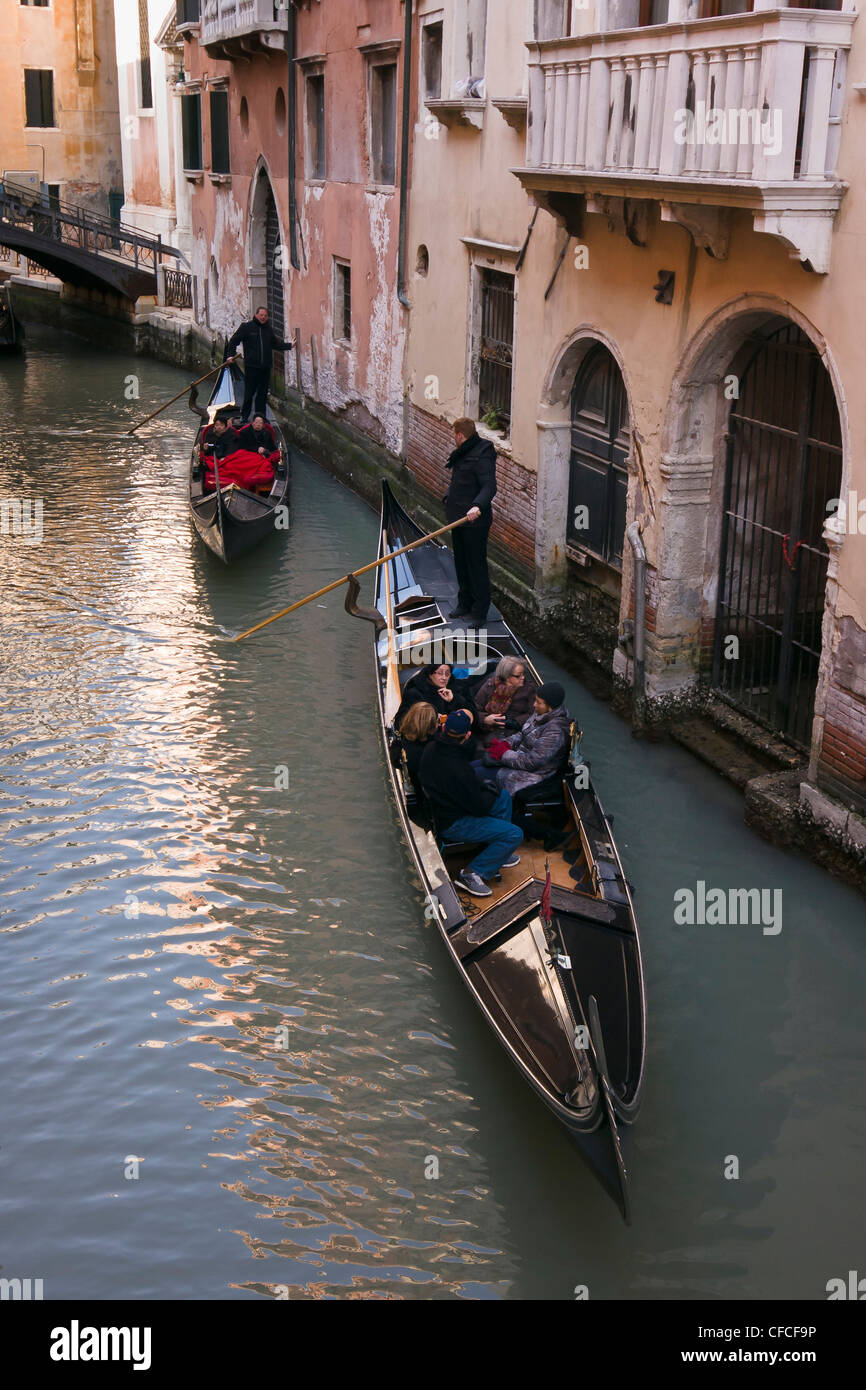 Tourists enjoying a gondola ride on Rio San Luca canal - Venice ...