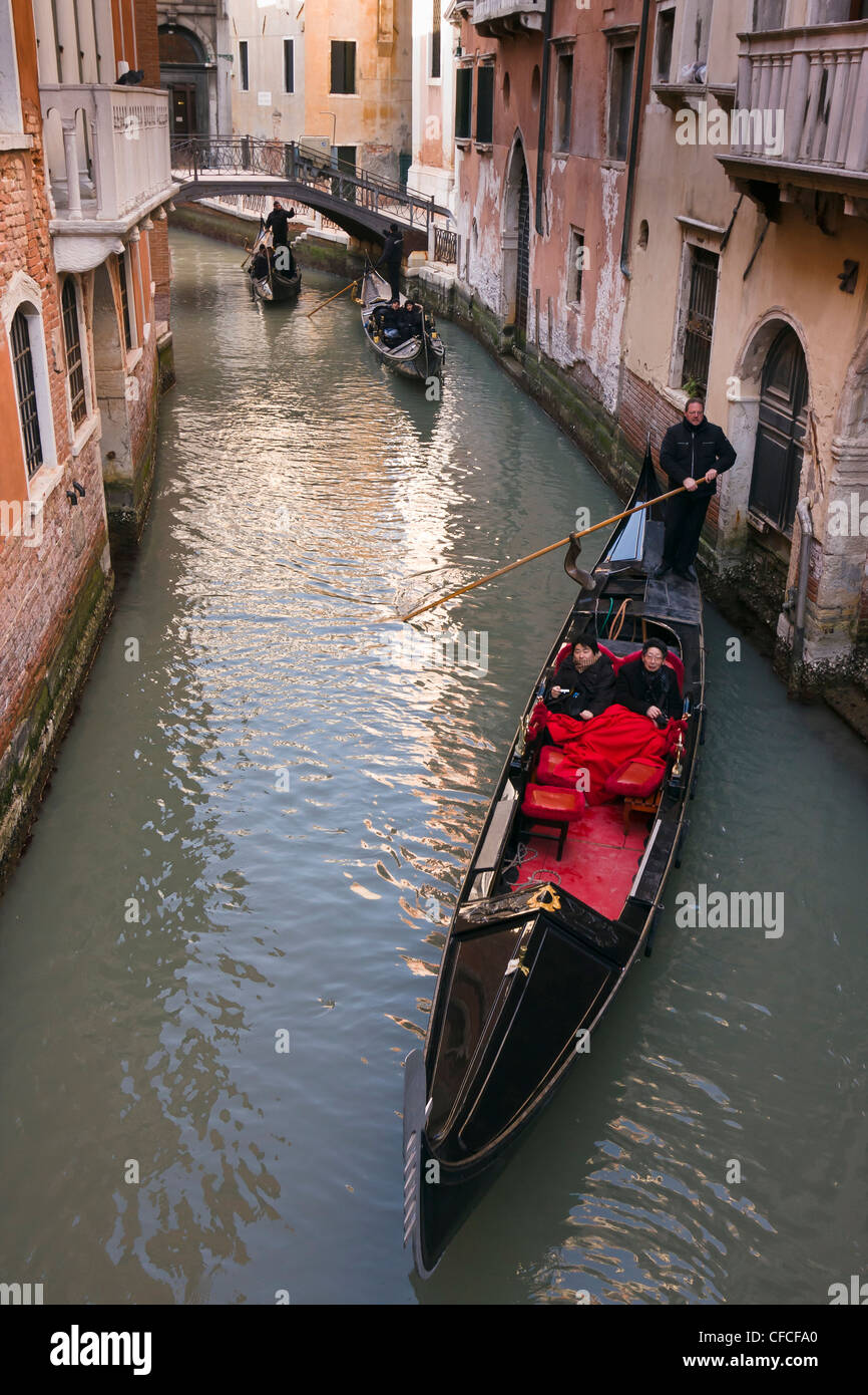 Tourists enjoying a gondola ride on Rio San Luca canal - Venice ...
