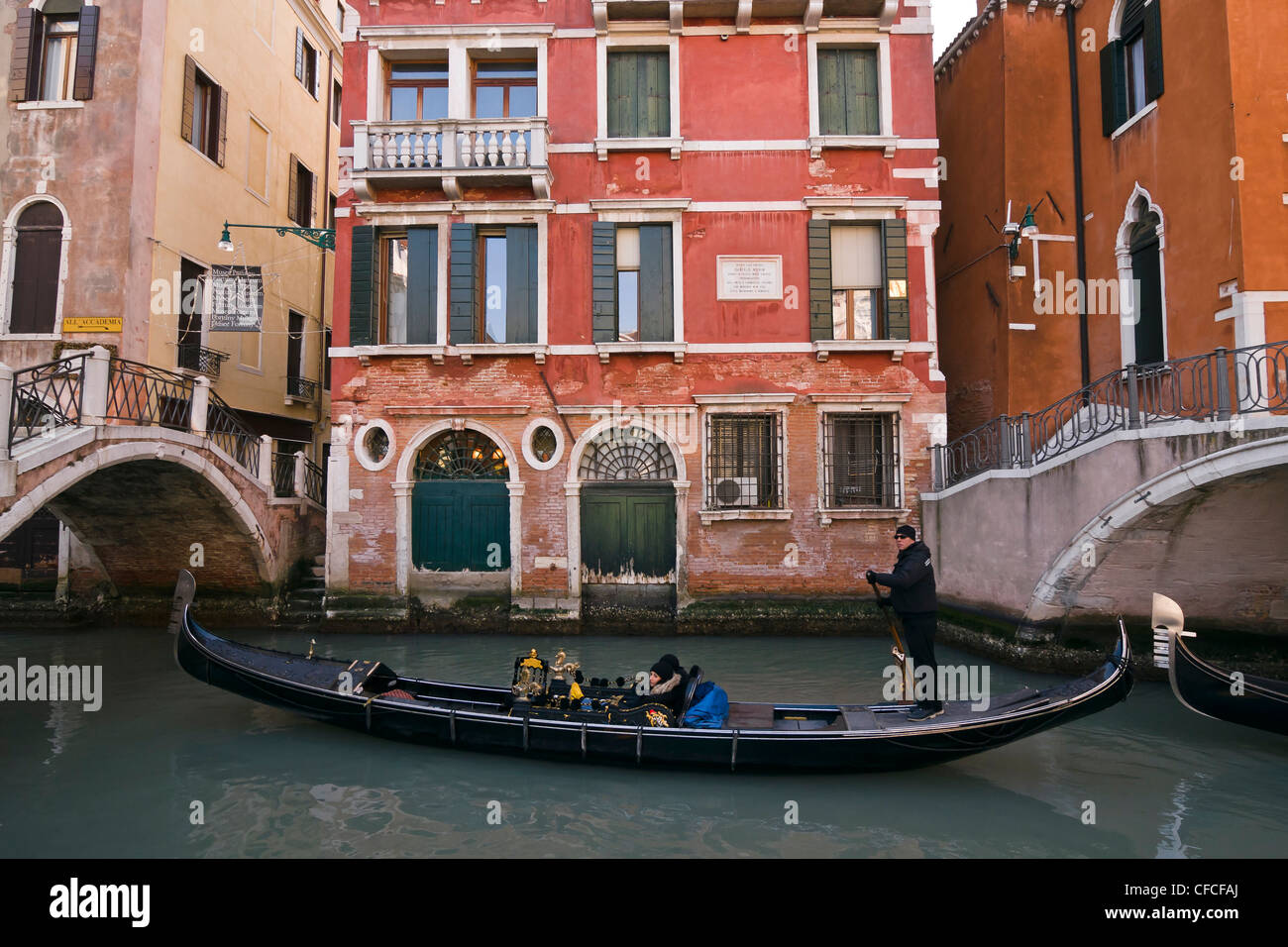 Tourists enjoying a gondola ride on Rio San Luca canal - Venice ...
