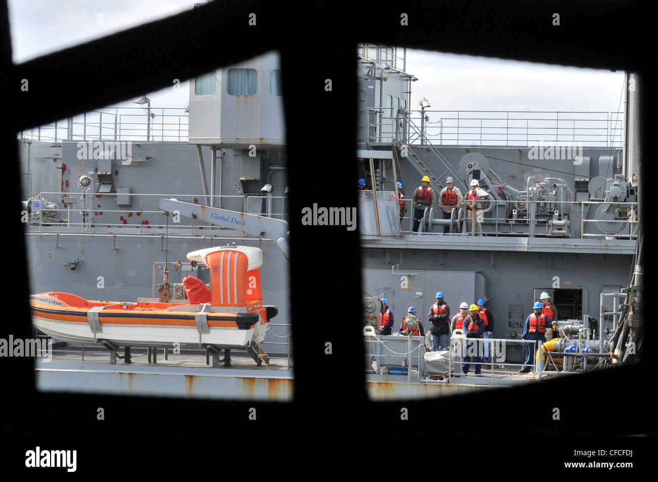 Crew members of the Military Sealift Command dry cargo/ammunition ship ...